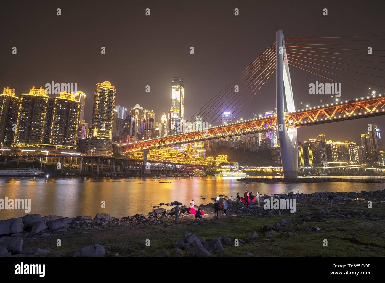 --FILE--Night view of the Qiansimen Jialing River Bridge leading to ...