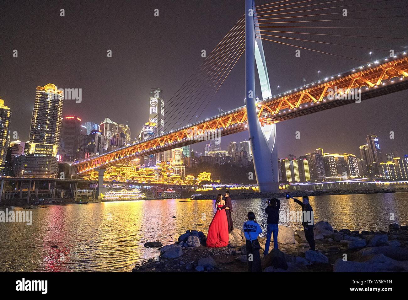 --FILE--Night view of the Qiansimen Jialing River Bridge leading to ...