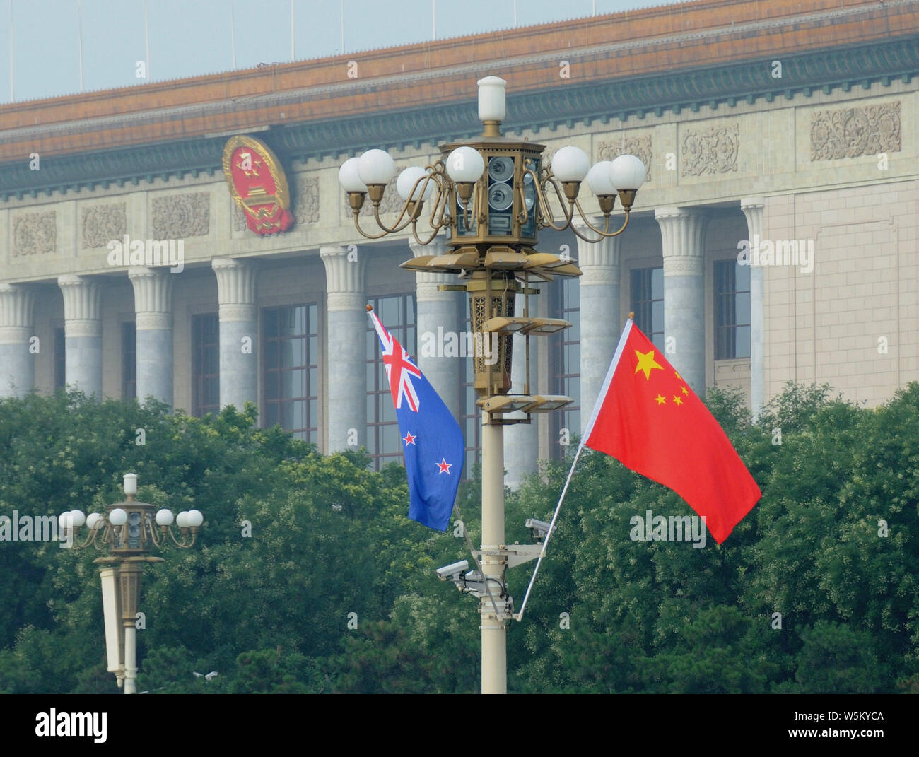 --FILE--Chinese and New Zealand national flags flutter on a lamppost on ...
