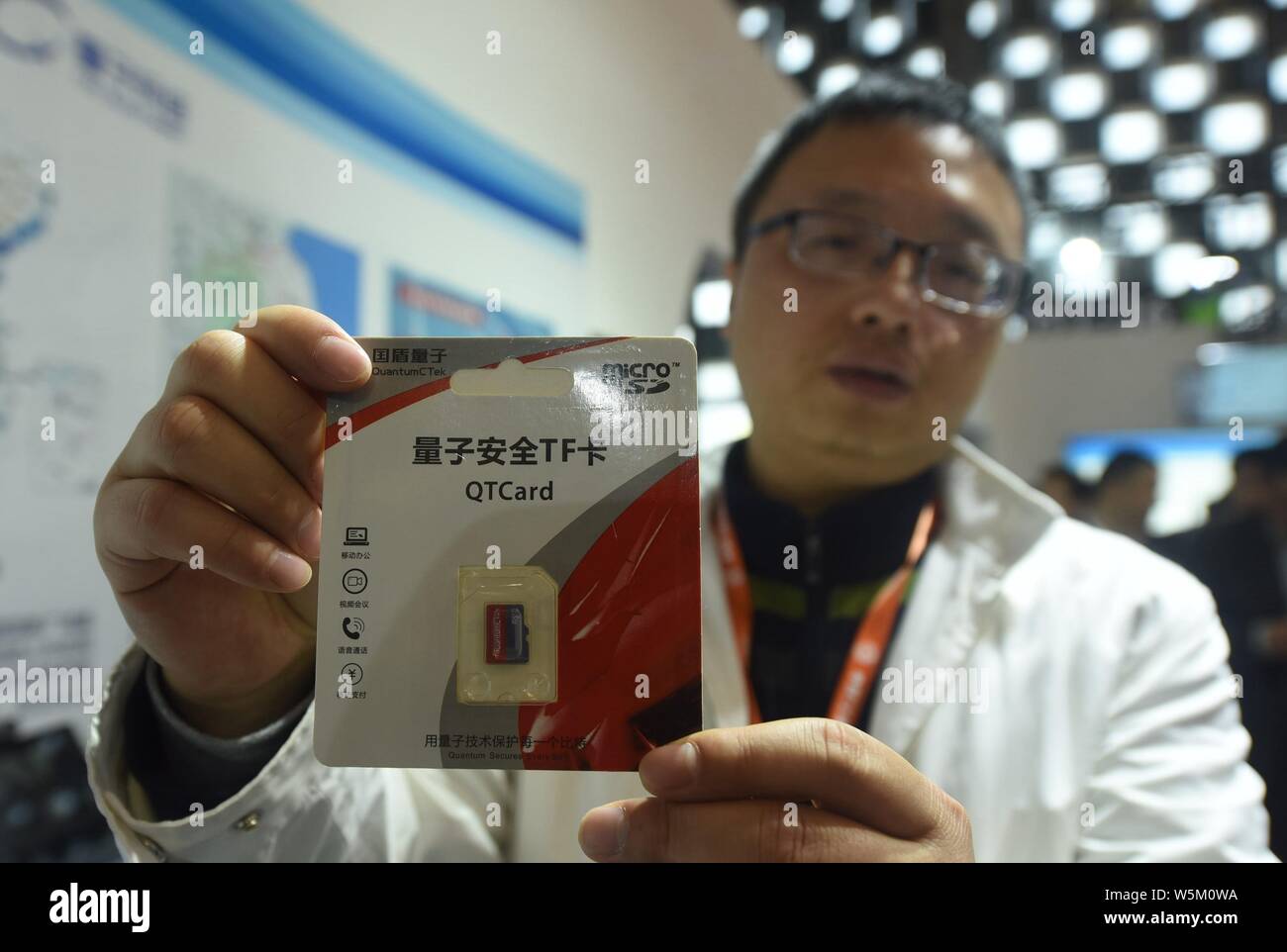 A Chinese employee shows a QT card at the stand of QuantumCTek Co., Ltd ...