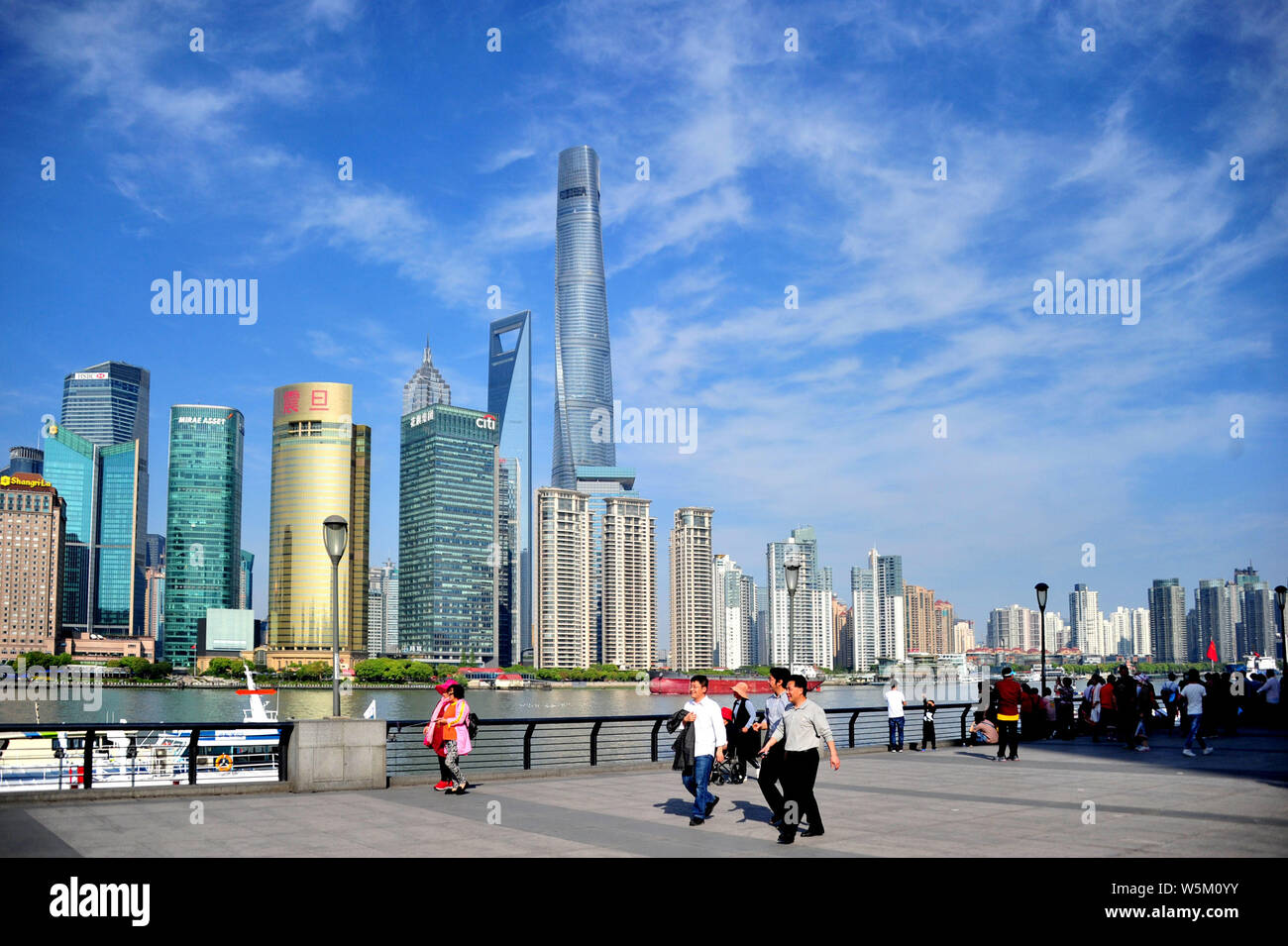 Pedestrians walk under the hot weather at the Bund or Waitan in ...