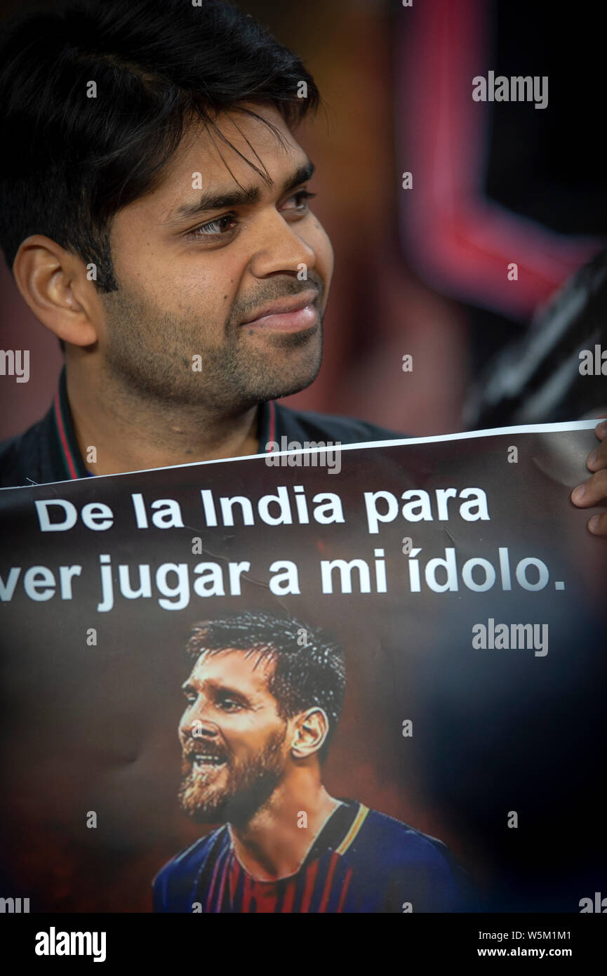 An Indian football fan displays a poster saying "I came from India to ...