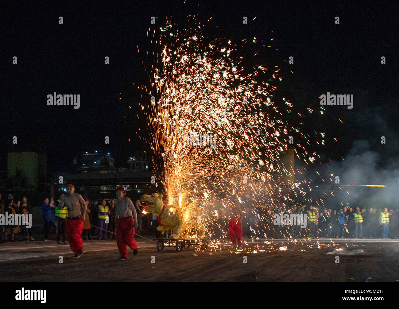 Chinese villagers push the paper tiger and flames were splashed high ...