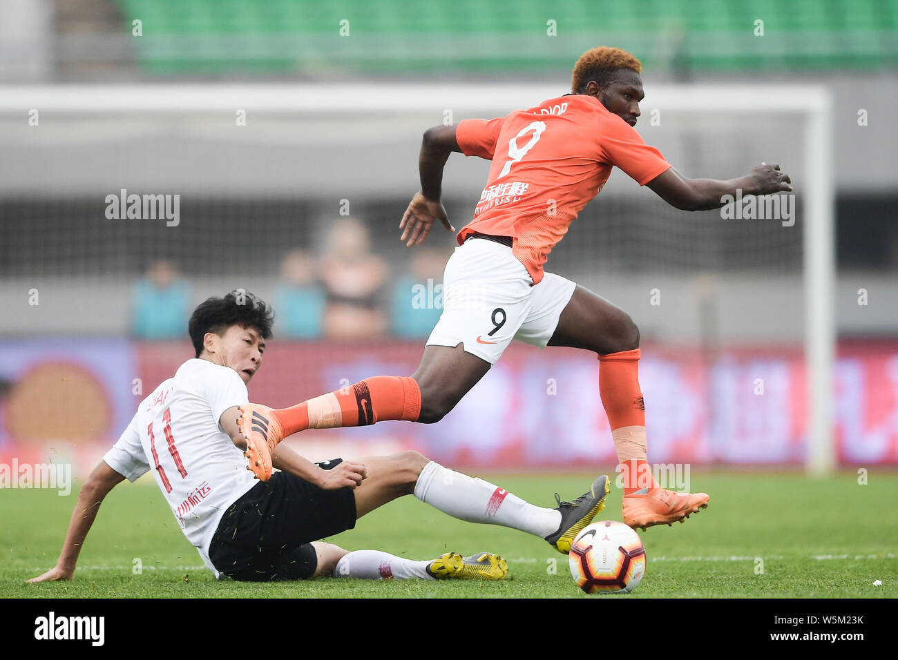 Senegalese football player Makhete Diop, right, of Beijing Renhe F.C ...