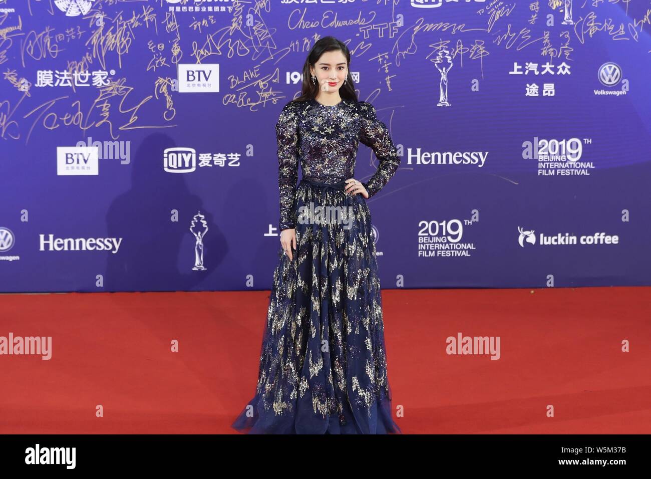 Hong Kong actress Angelababy poses as she arrives on the red carpet for the opening ceremony of ...