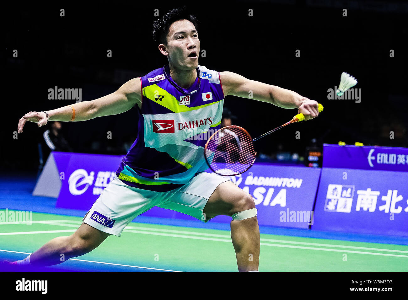 Kento Momota of Japan returns a shot to Lee Dong-keun of South Korea in ...