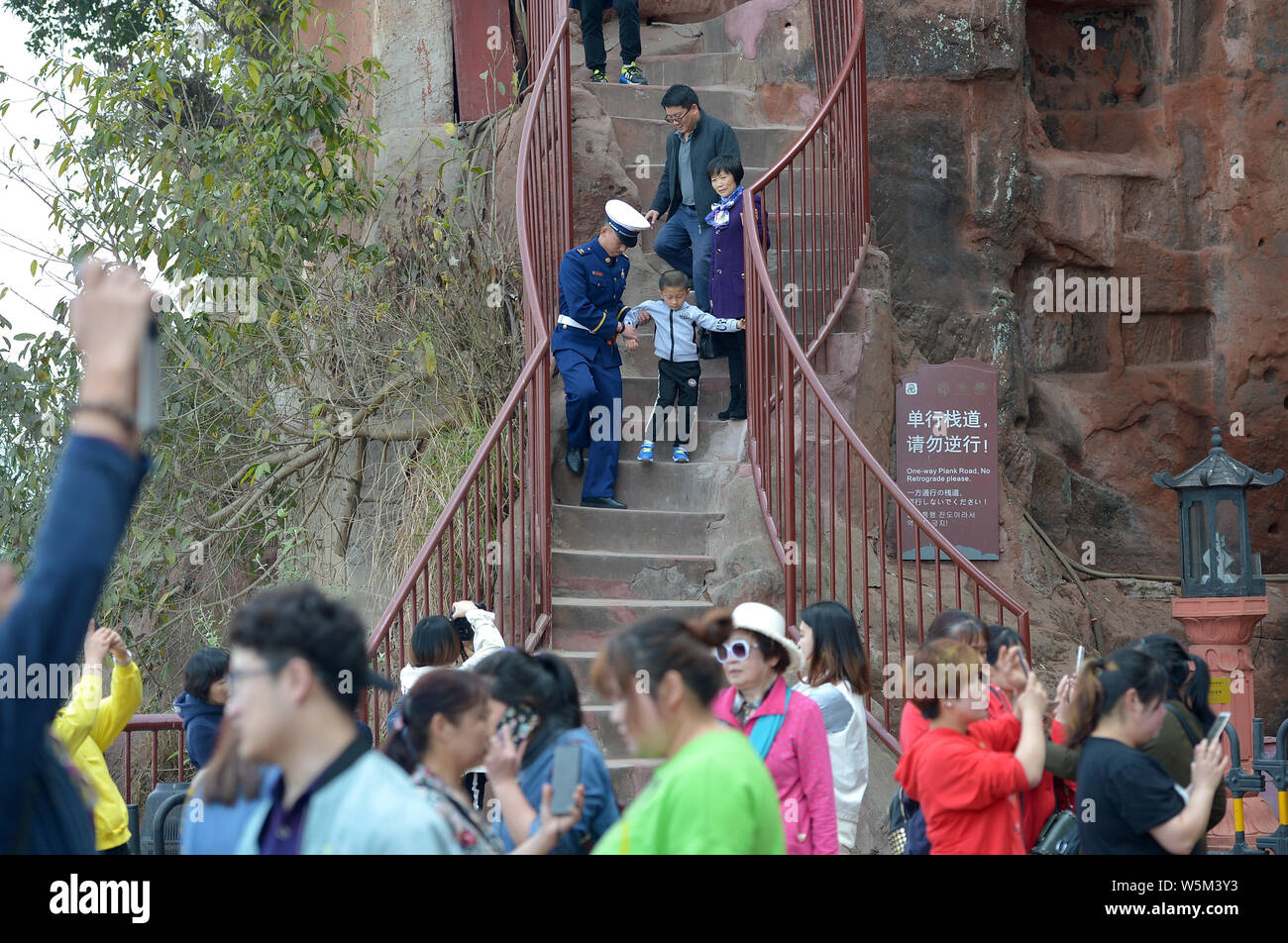 Tourists view the Leshan Giant Buddha after renovating its damaged ...