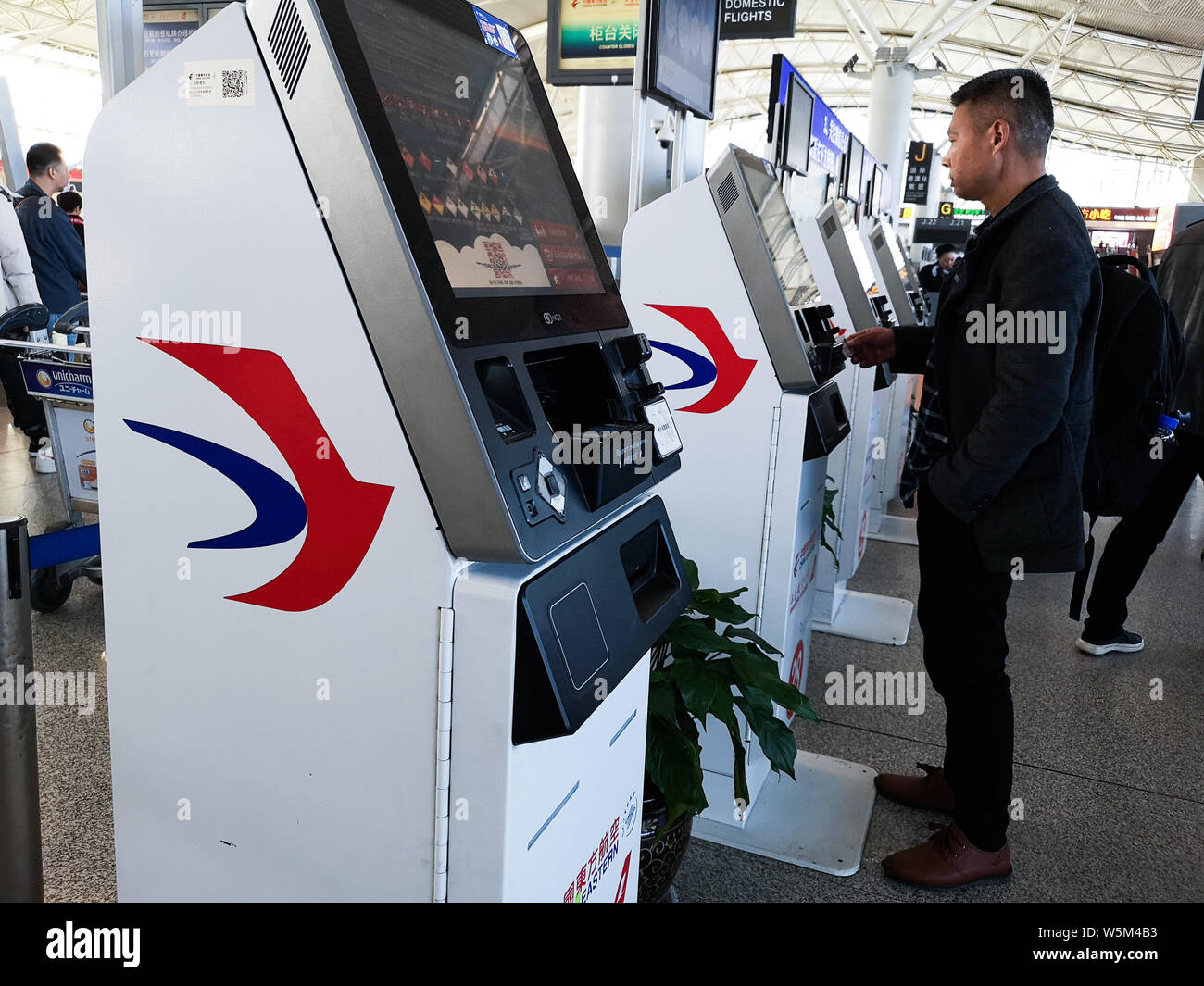 --FILE--A passenger uses self-service electronic ticket check-in ...