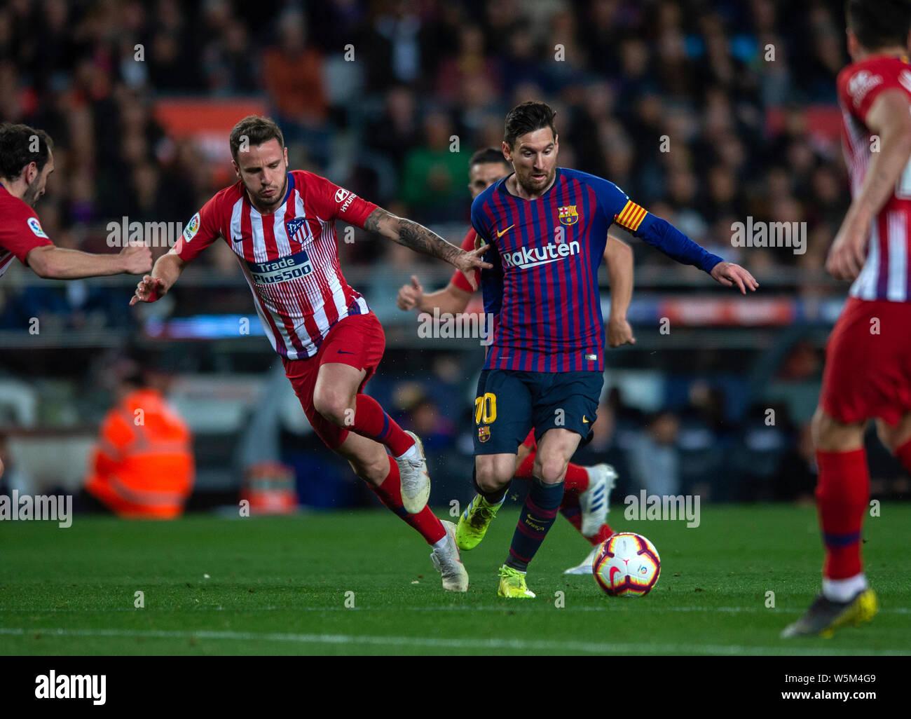 Lionel Messi of FC Barcelona, center, challenges Koke of Club Atletico ...