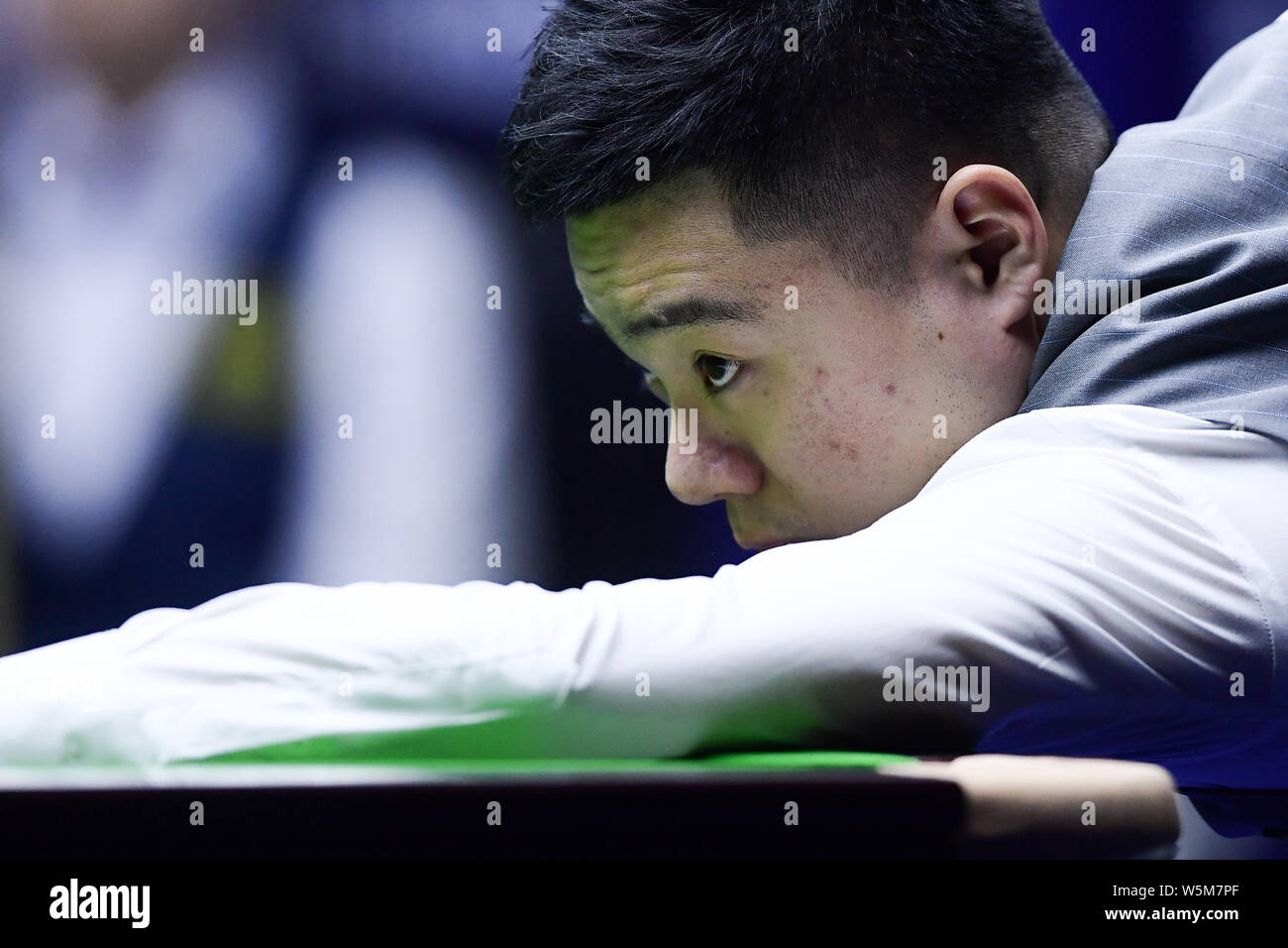 Ding Junhui of China plays a shot to Zhang Jiankang of China in the ...