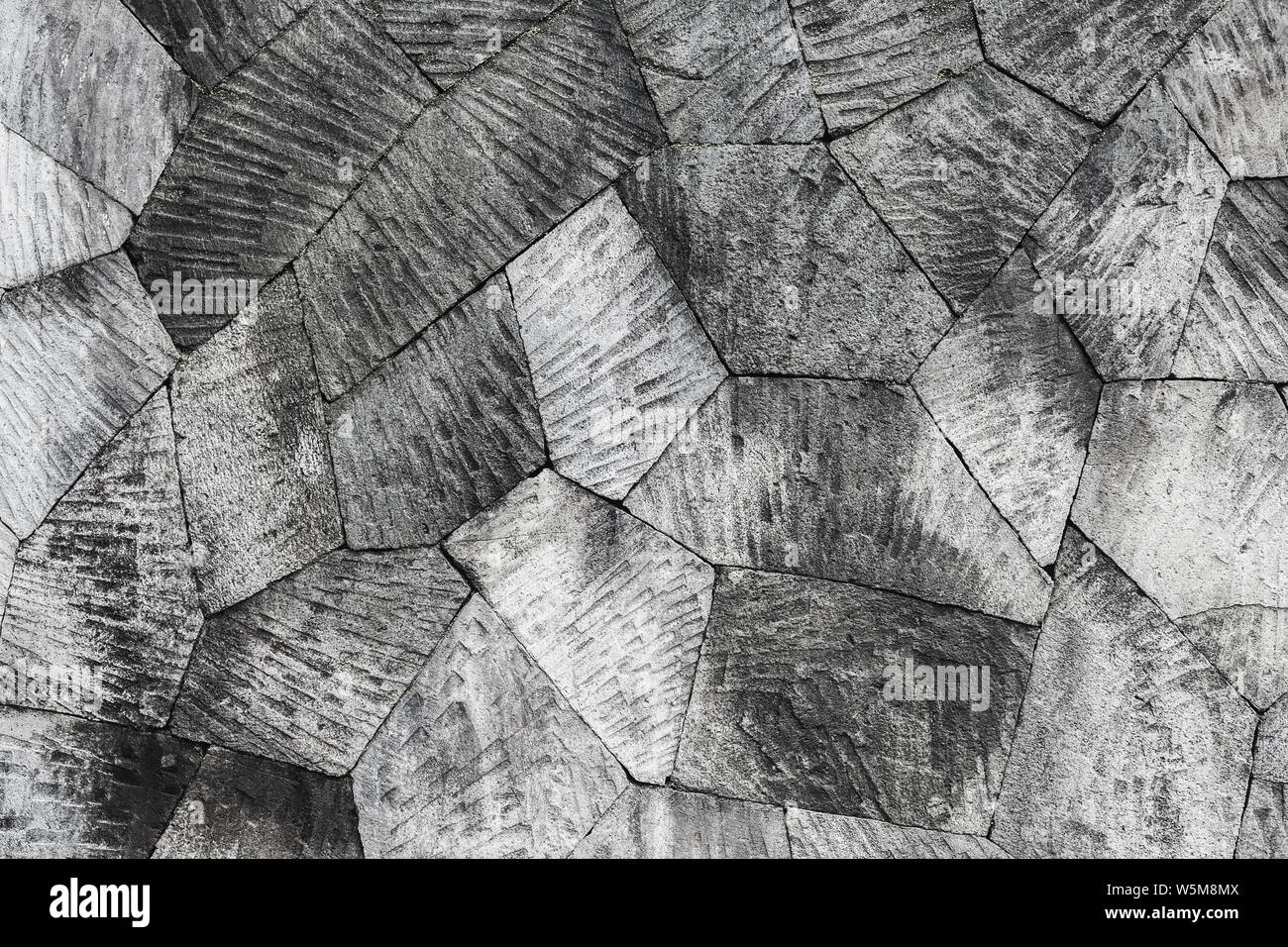 Grey stone wall background, pattern with different geometric shapes ...