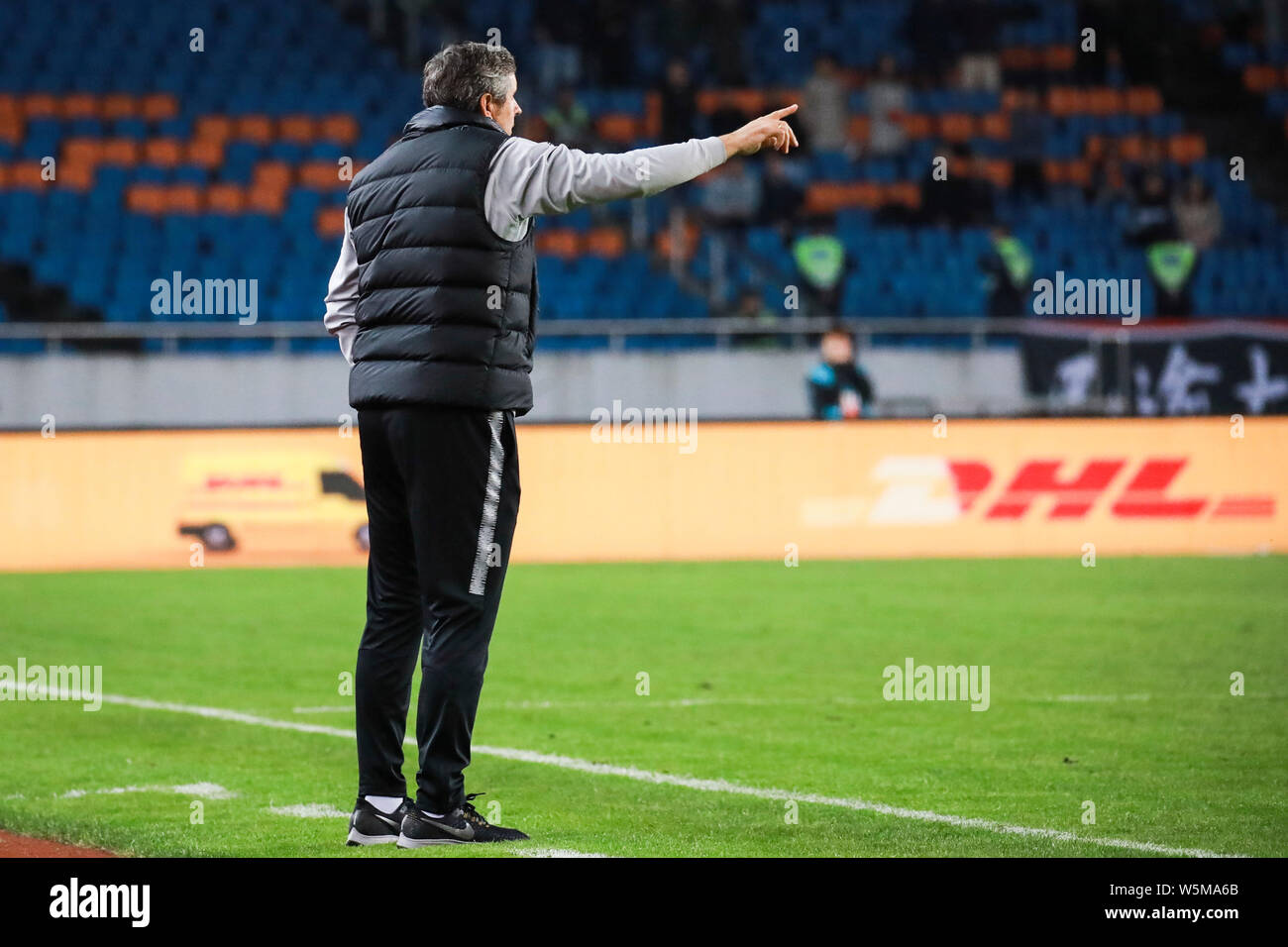 Head coach Juan Ramon Lopez Caro of Shenzhen F.C. reacts as he watches ...