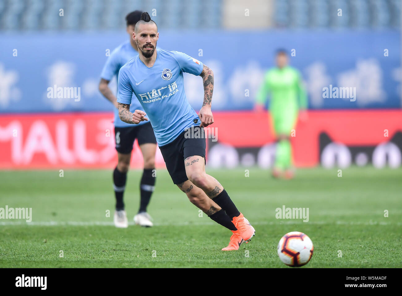 Slovak football player Marek Hamsik, right, of Dalian Yifang dribbles ...