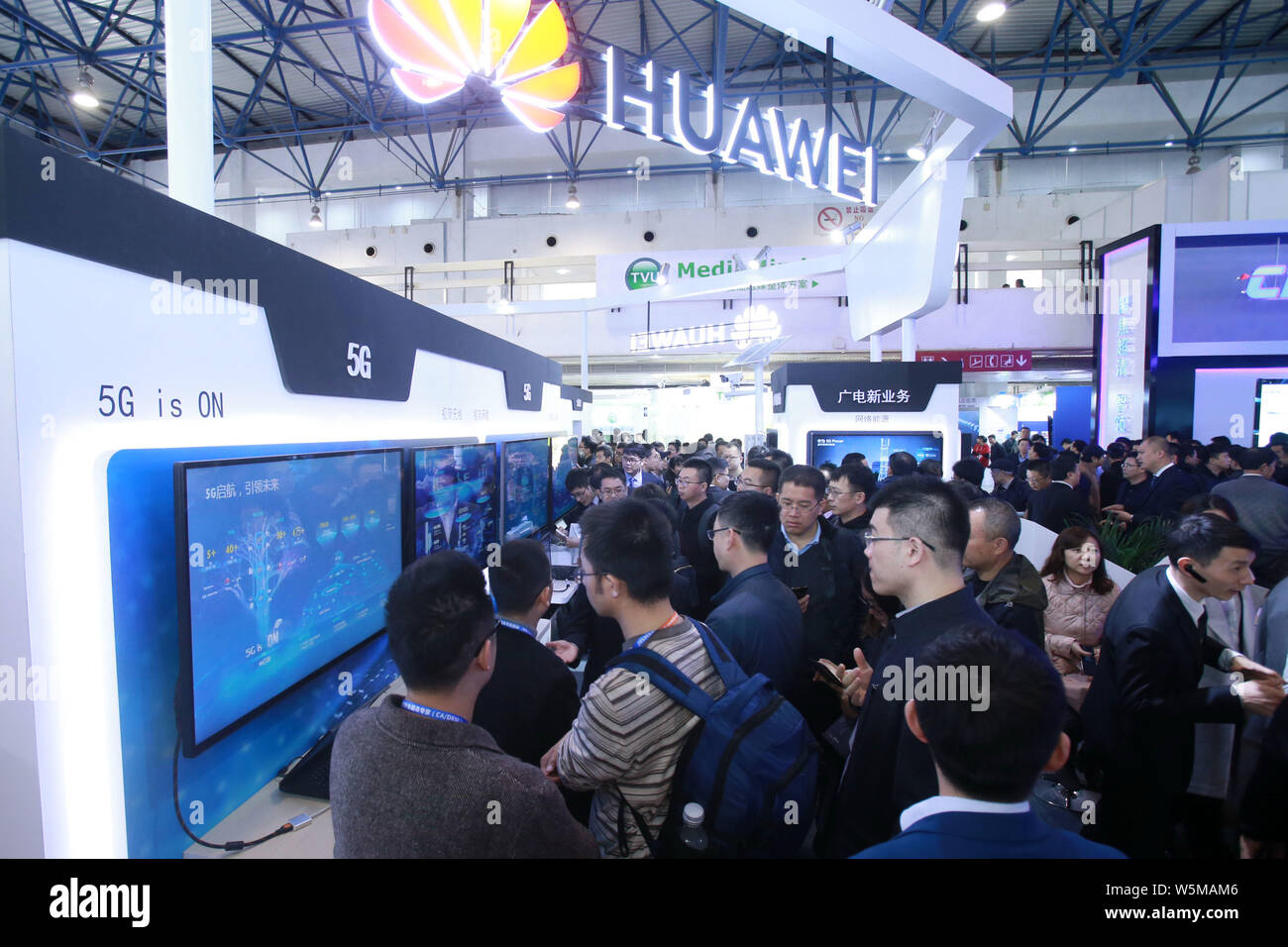 --FILE--People visit the stand of Huawei featuring 5G network during an ...
