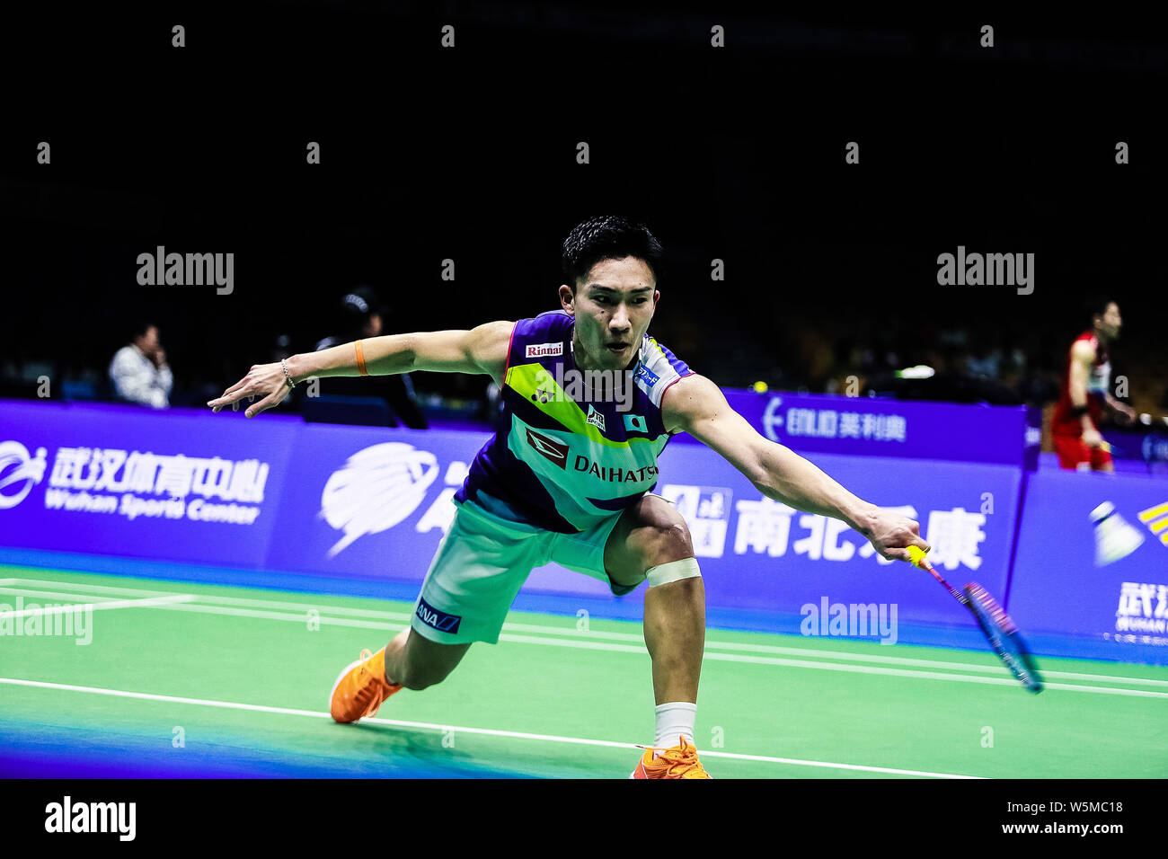 Kento Momota of Japan returns a shot to Lee Dong-keun of South Korea in ...