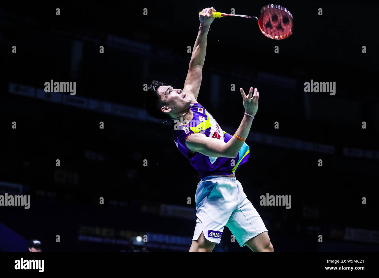 Kento Momota of Japan returns a shot to Lee Dong-keun of South Korea in ...