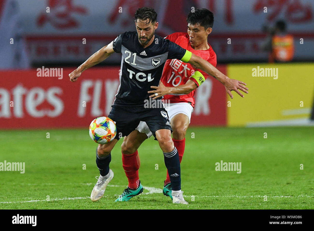 Carl Valeri, left, of Australia's Melbourne Victory challenges Zheng ...