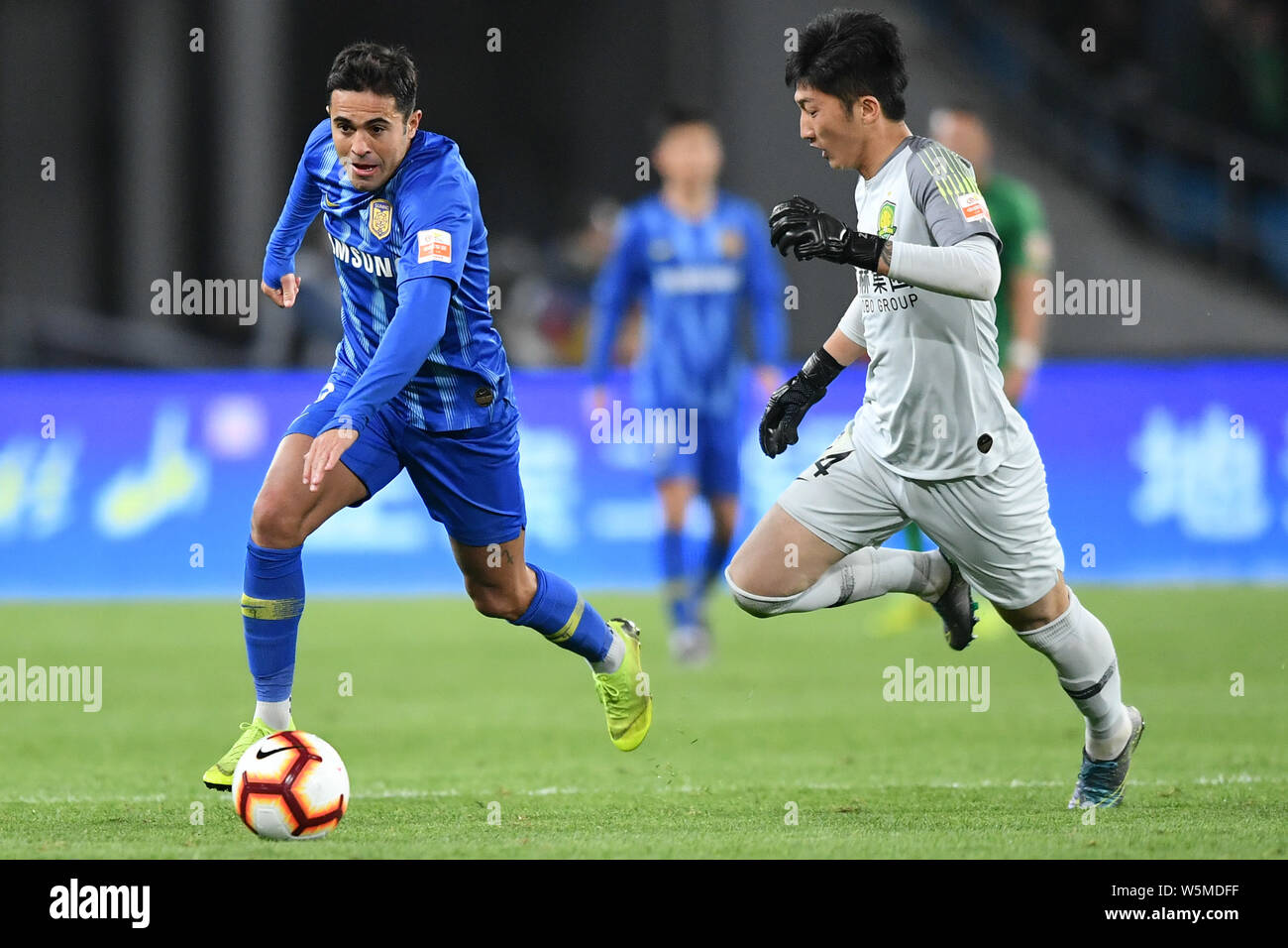 Zou Dehai, right, of Beijing Sinobo Guoan F.C. challenges Italian ...