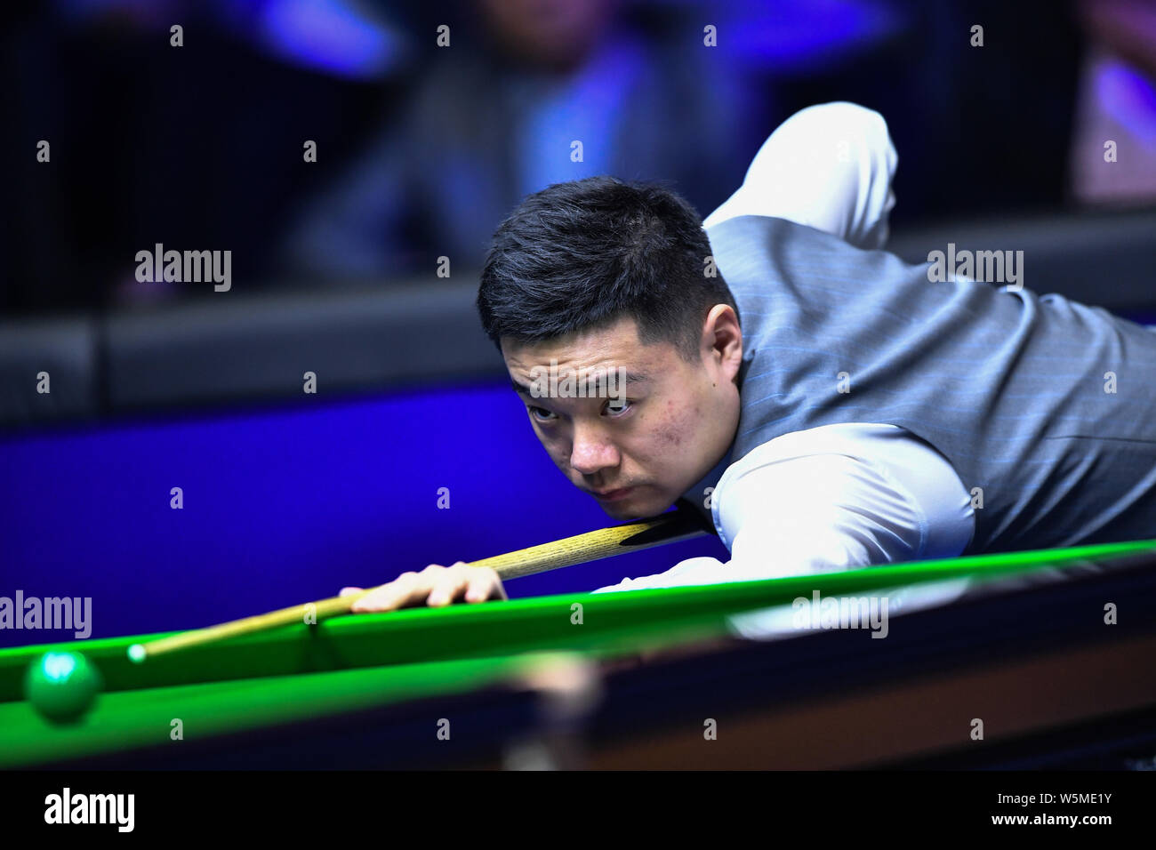 Ding Junhui of China plays a shot to James Wattana of Thailand in the ...