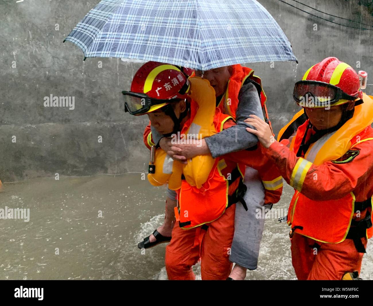 Chinese rescuers evacuate local residents in floodwater after a heavy ...