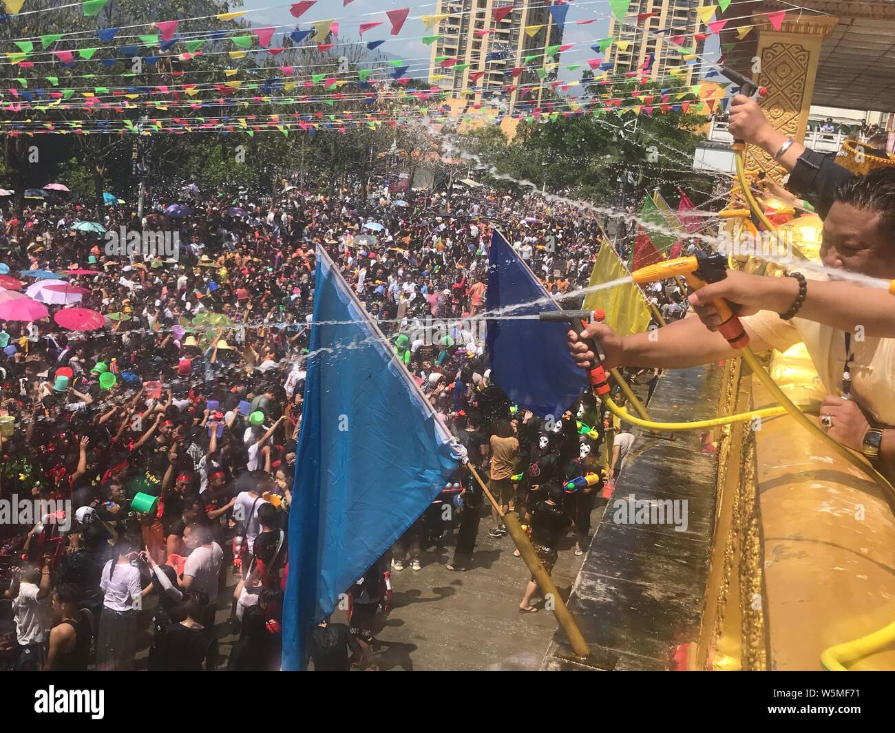 People sprinkle water to each other to celebrate the water-sprinkling ...