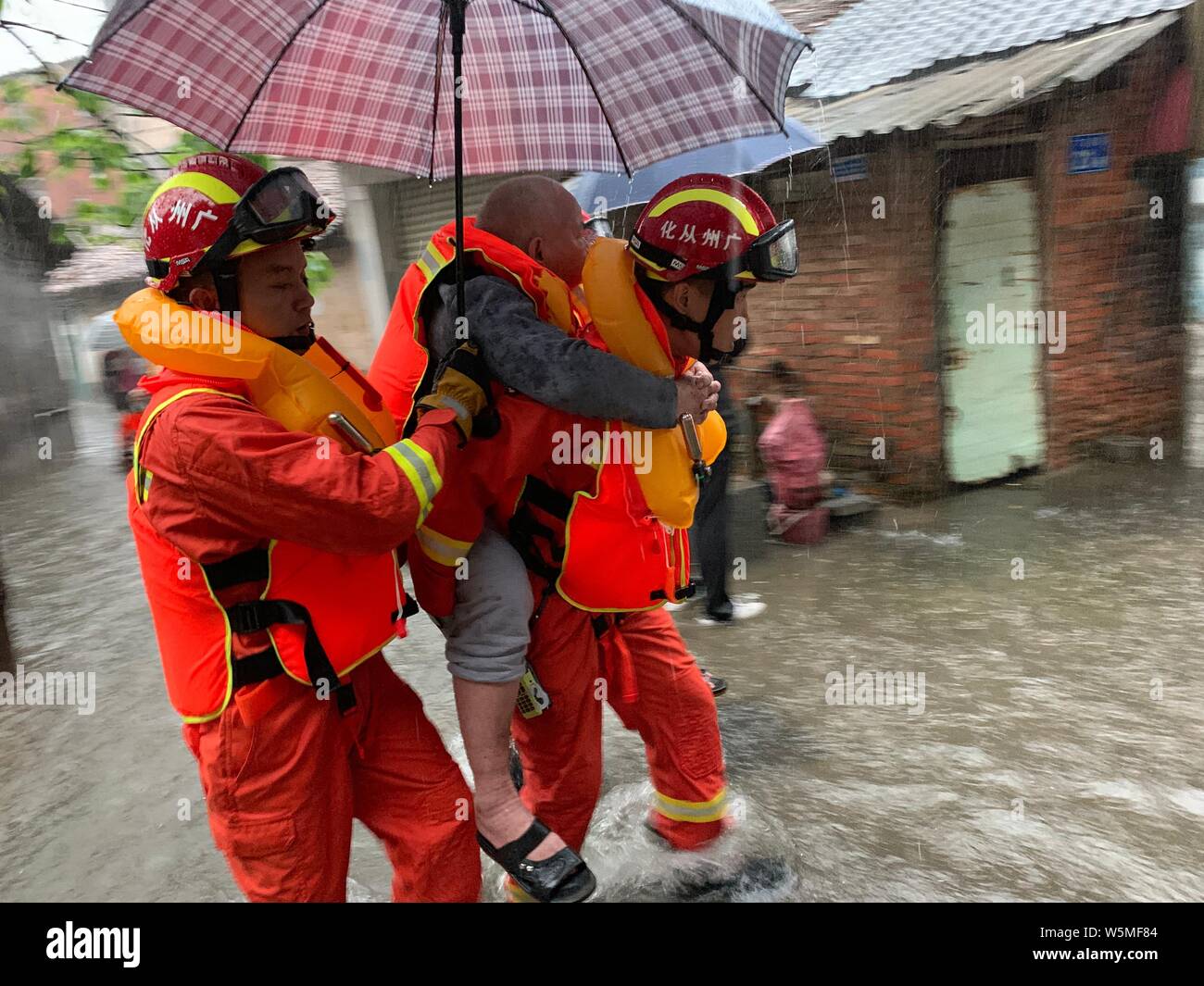 Chinese rescuers evacuate local residents in floodwater after a heavy ...