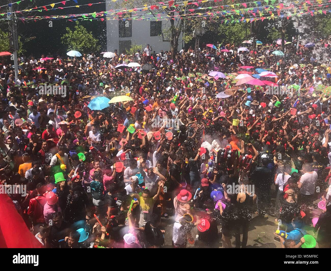 People sprinkle water to each other to celebrate the water-sprinkling ...