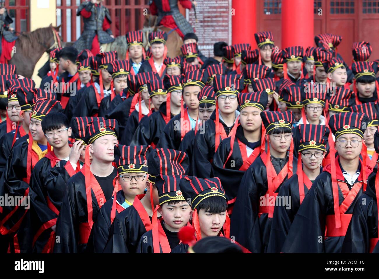 Students dressed in ancient Chinese costumes attend a traditional ...