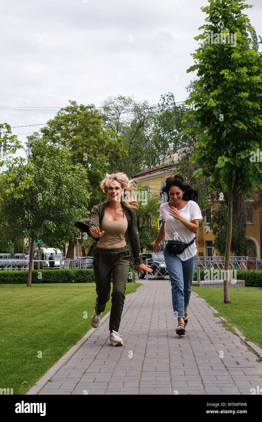 Girls are in a hurry. Friends run, they are late and laugh. Always near ...