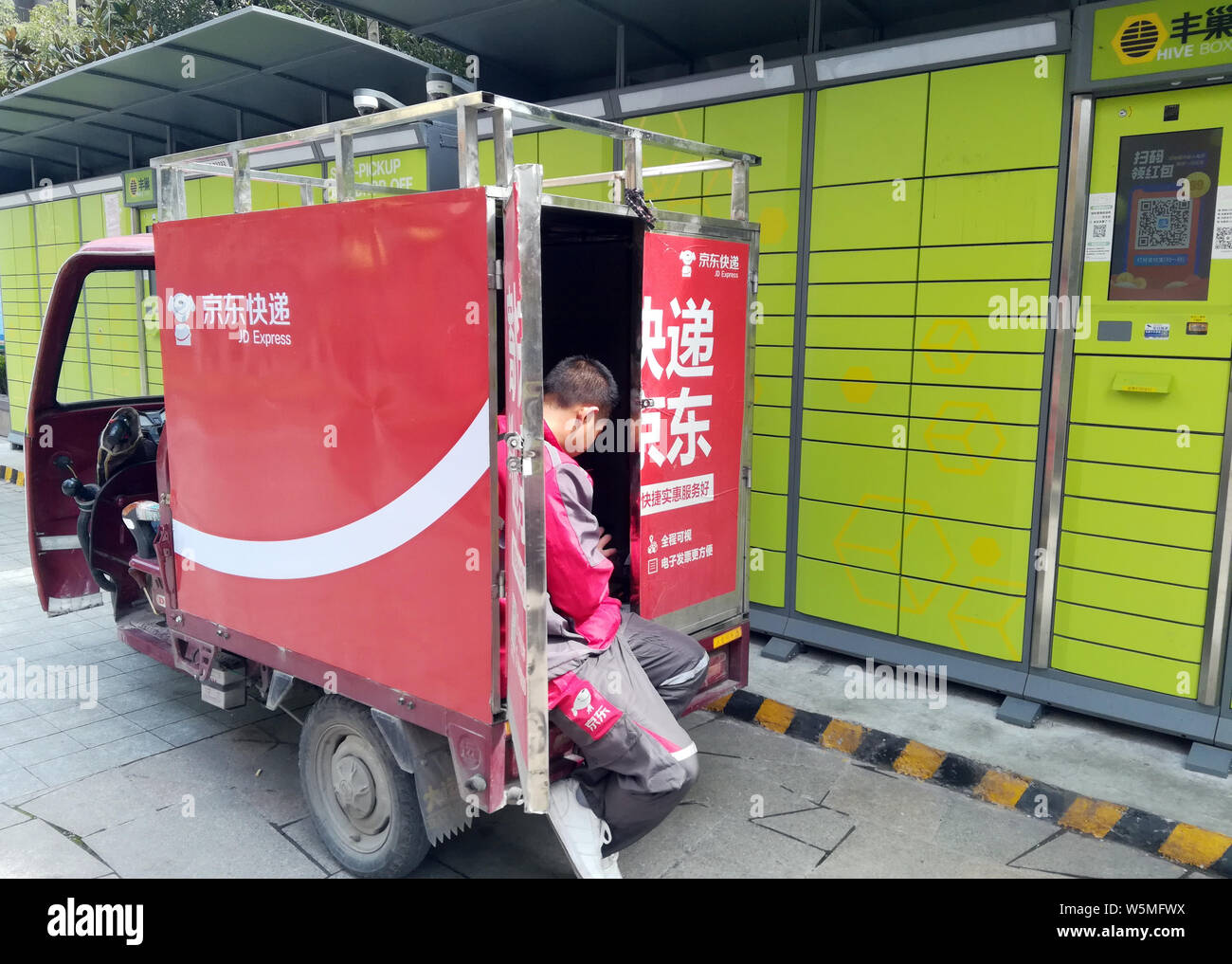 --FILE--A courier of Chinese e-commerce giant JD delivers parcels in ...