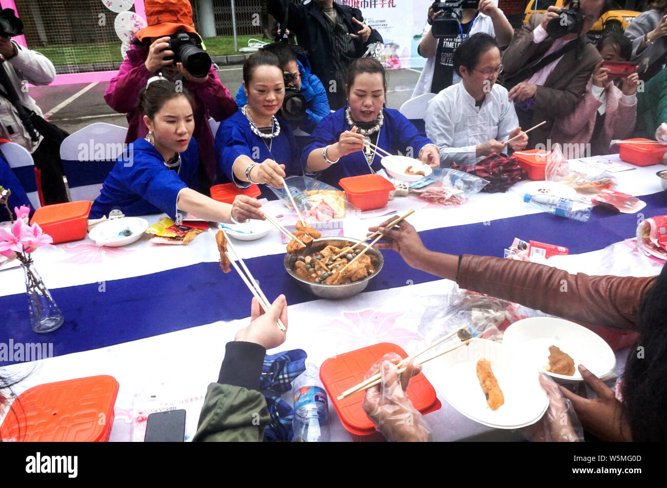 Local residents eat Luosifen, a local rice noodle dish featuring cooked ...