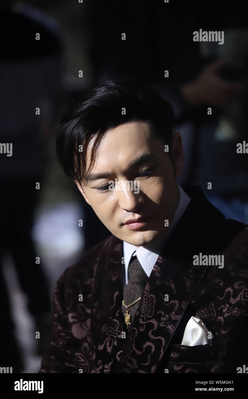 Chinese actor Huang Xiaoming poses during a filming session on set of ...