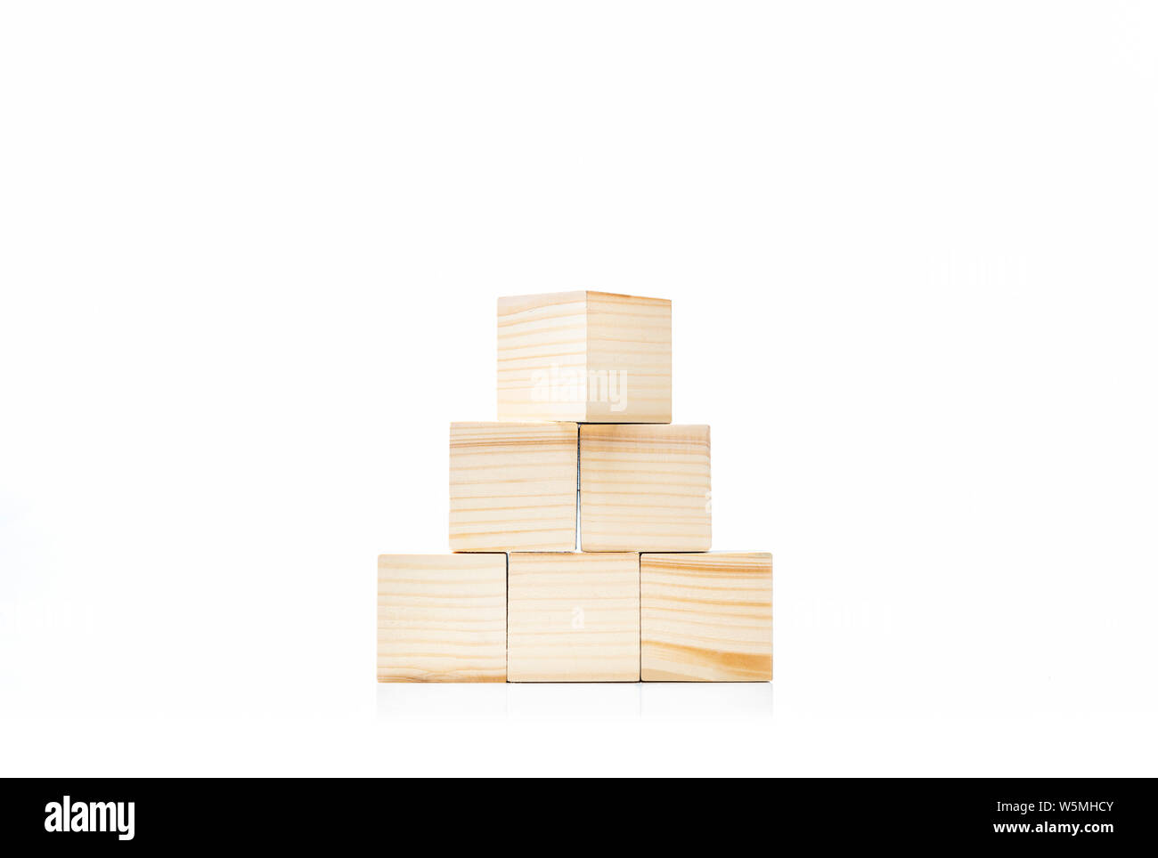 Wooden block toy with a pyramid shape isolated over white background ...