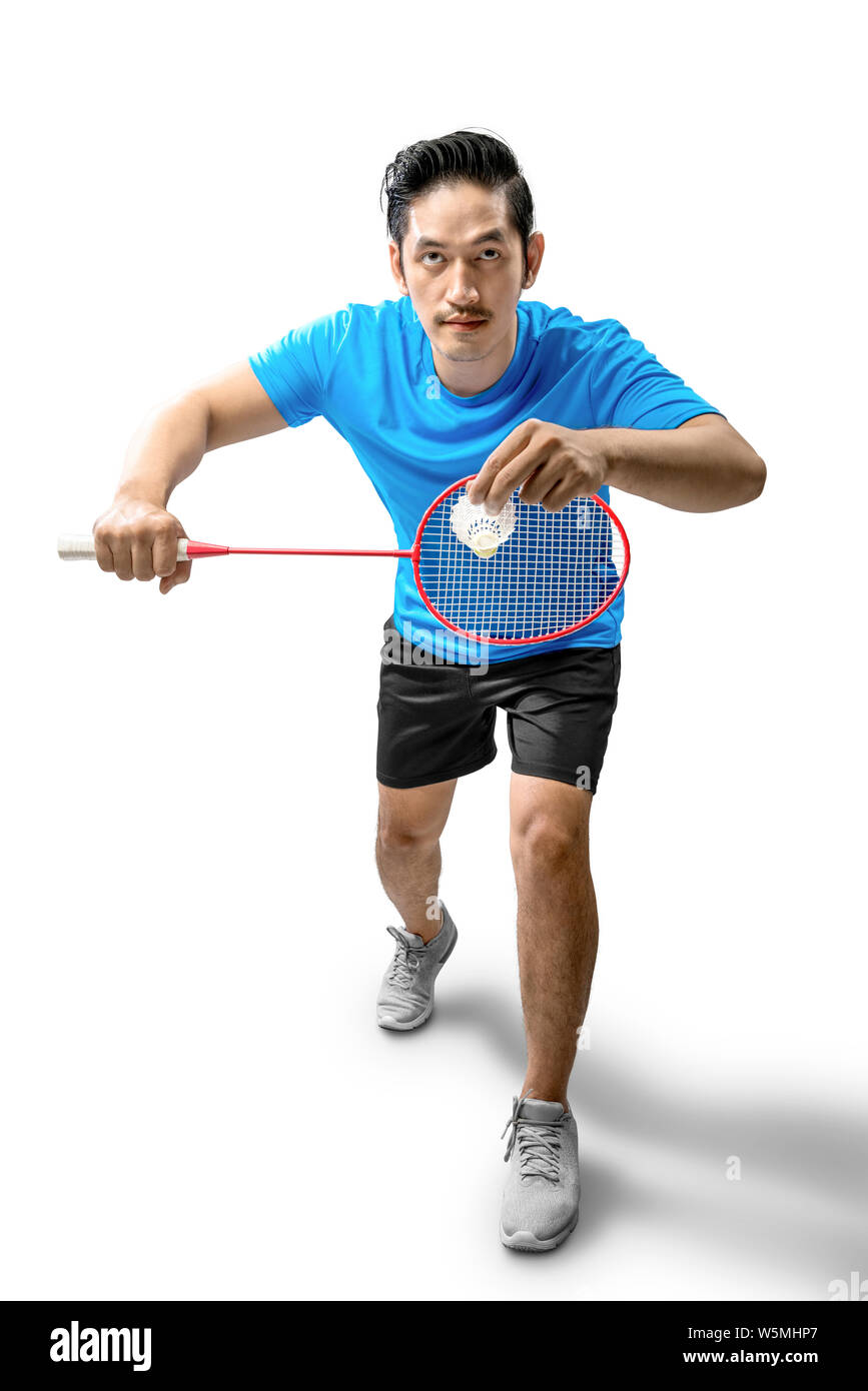 Asian man with badminton racket holding shuttlecock and ready in serve ...
