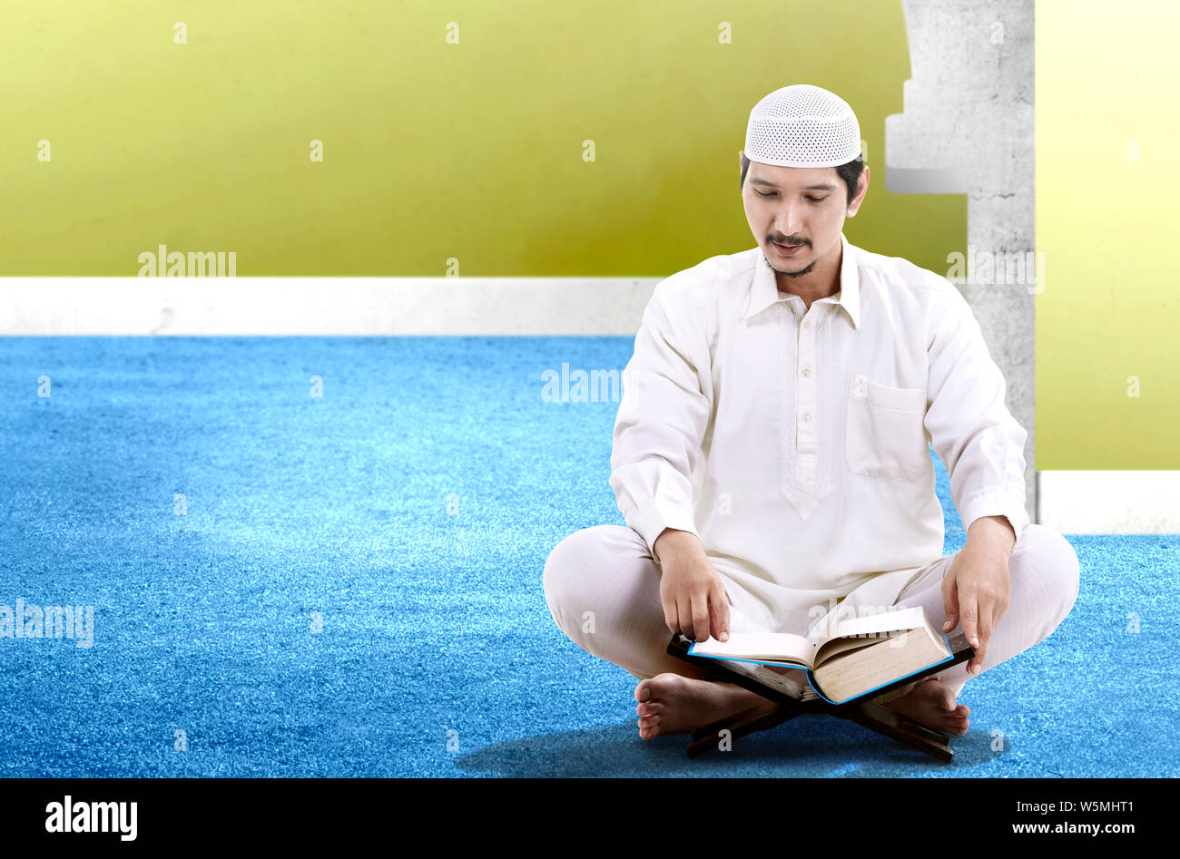 Asian Muslim man sitting and read the Koran inside the mosque Stock ...