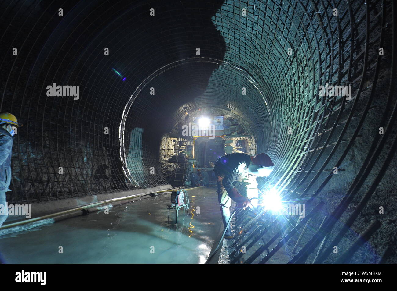 Chinese workers construct tunnel of water distribution system to ...