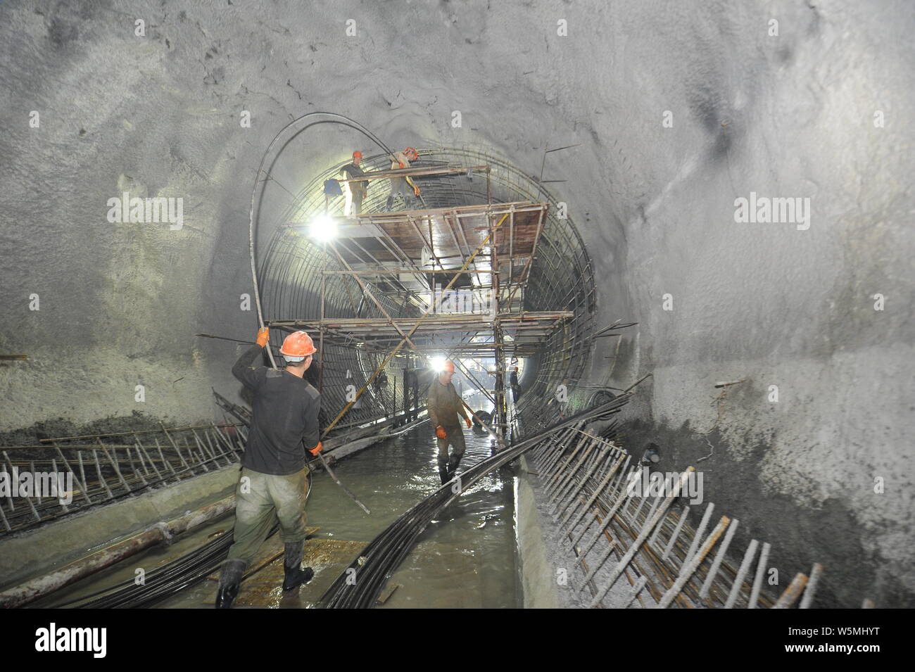 Chinese workers construct tunnel of water distribution system to ...