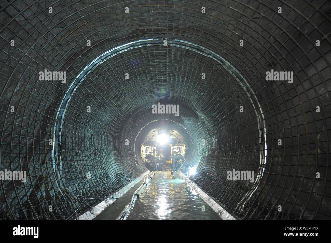 Chinese workers construct tunnel of water distribution system to ...