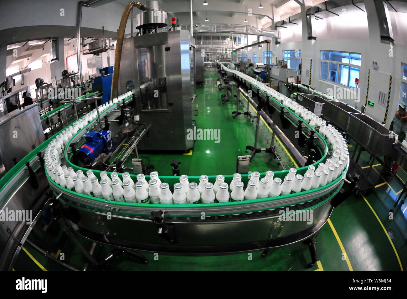 --FILE--A Chinese worker checks bottles of Wahaha AD calcium milk on ...