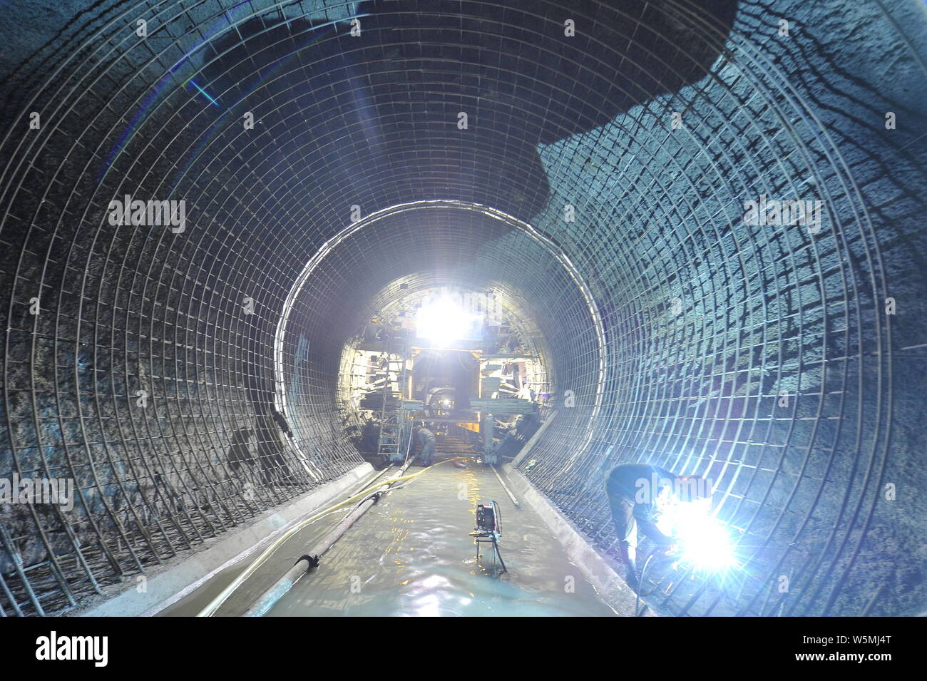 Chinese workers construct tunnel of water distribution system to ...