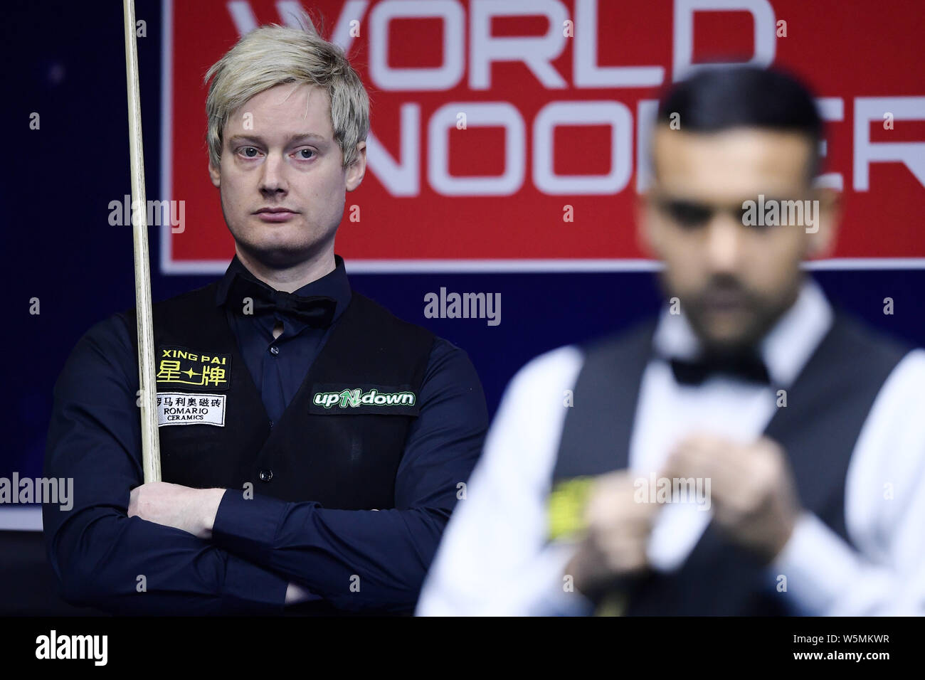 Neil Robertson of Australia reacts as he watches Kishan Hirani of Wales ...