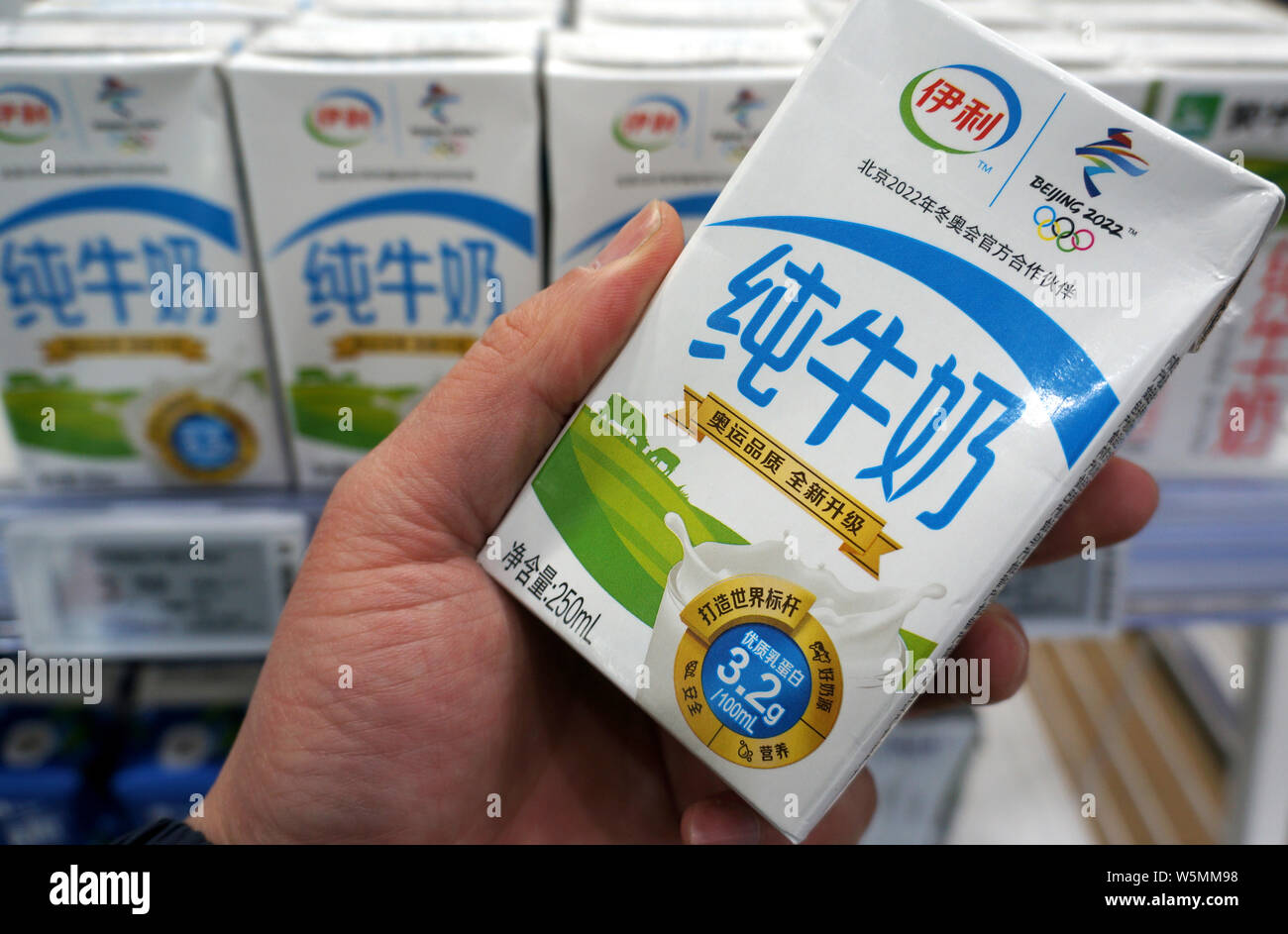 --FILE--A customer shops for a carton of Yili pure milk at a ...