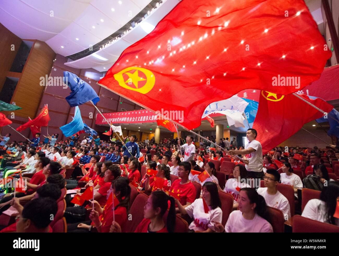 Young Chinese students from local universities wave flags of China and ...