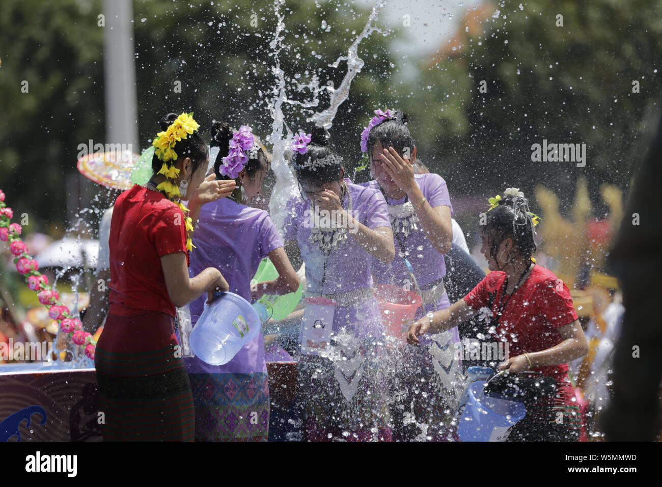 People sprinkle water to each other to celebrate the water-sprinkling ...