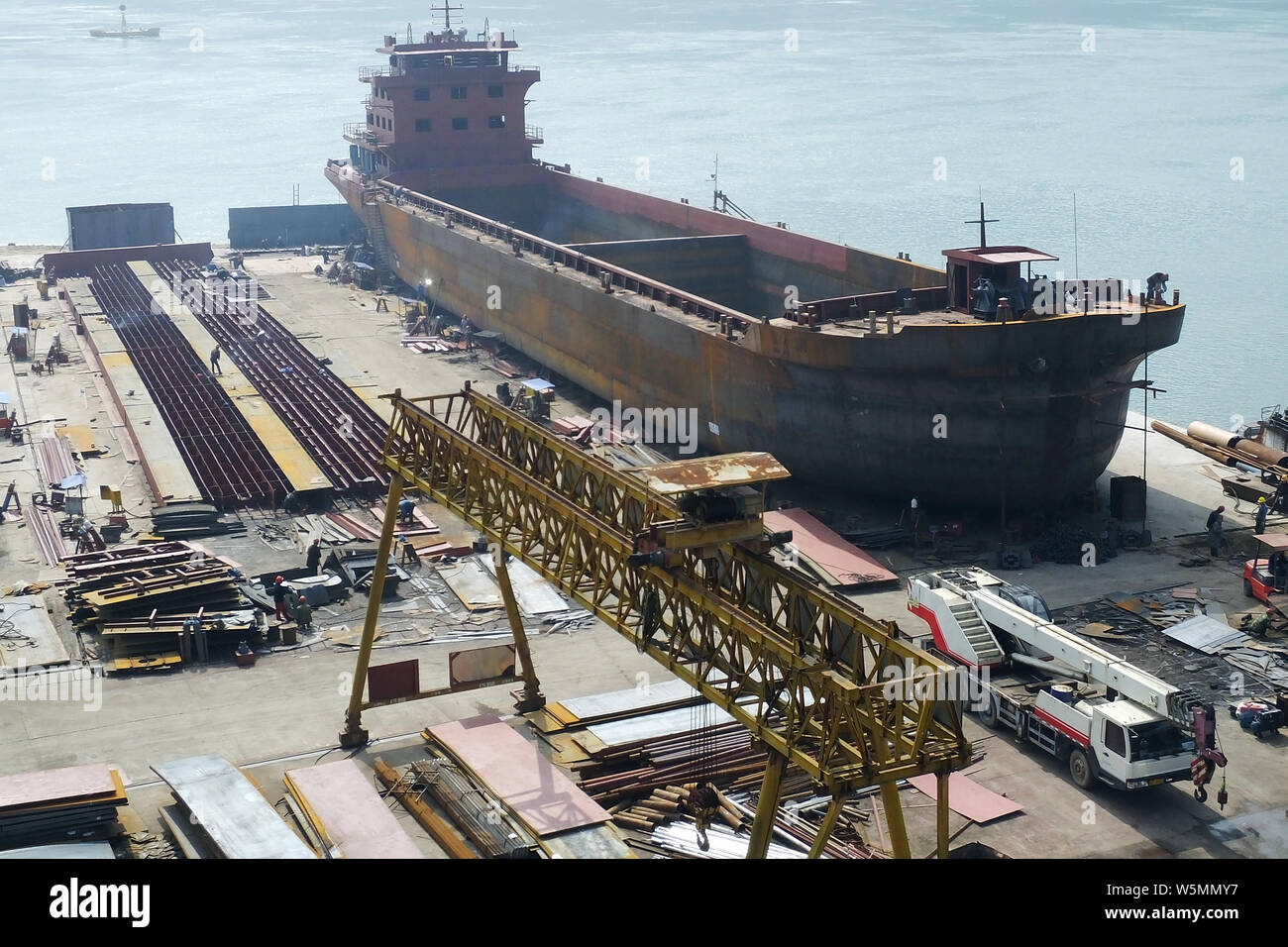 --FILE--Chinese workers manufacture a cargo ship at a factory in ...