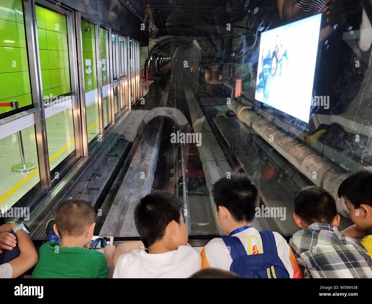 Children try out a subway train of Zhujiang New Town Automated People ...