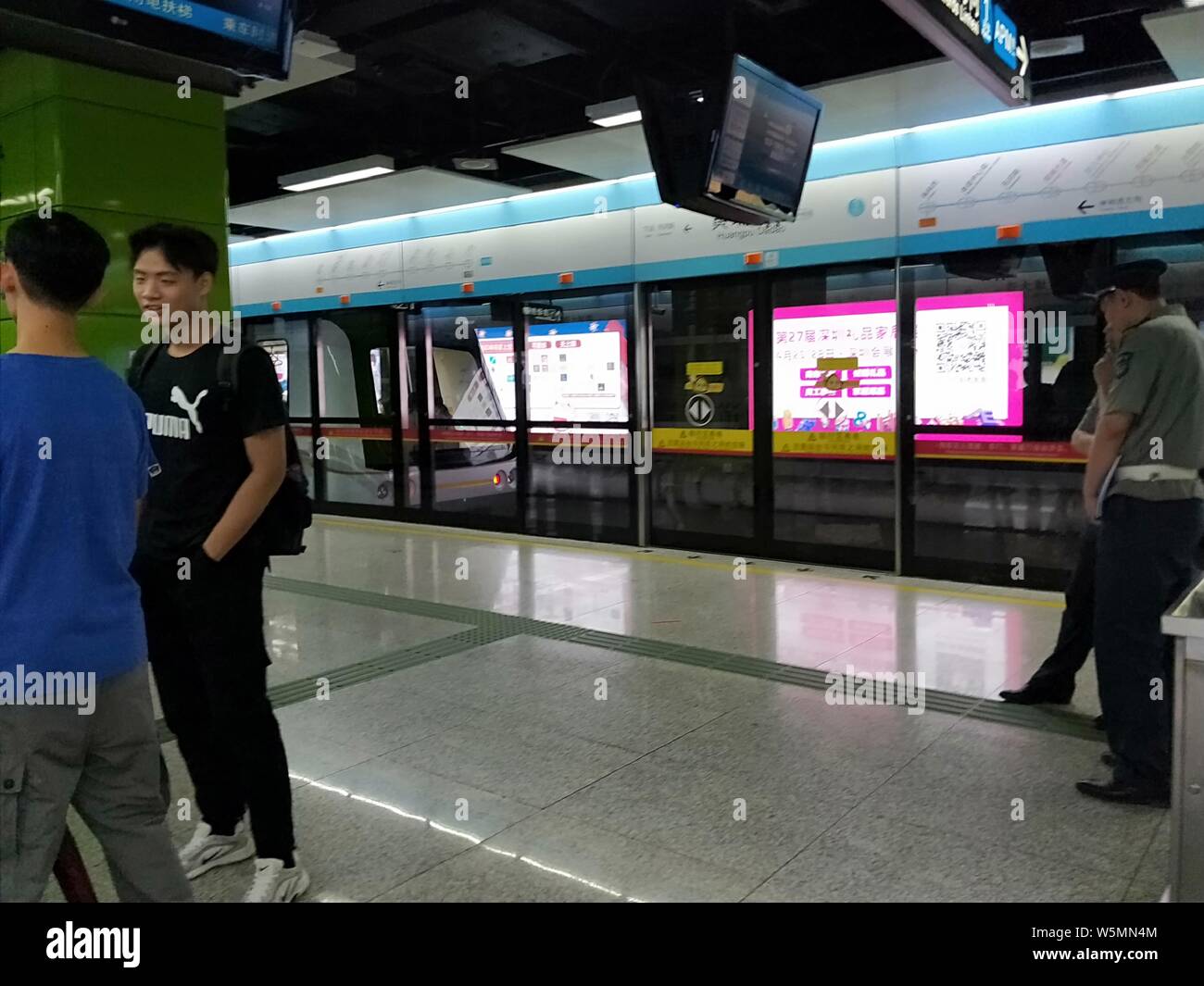 Passengers wait for their subway trains of Zhujiang New Town Automated ...