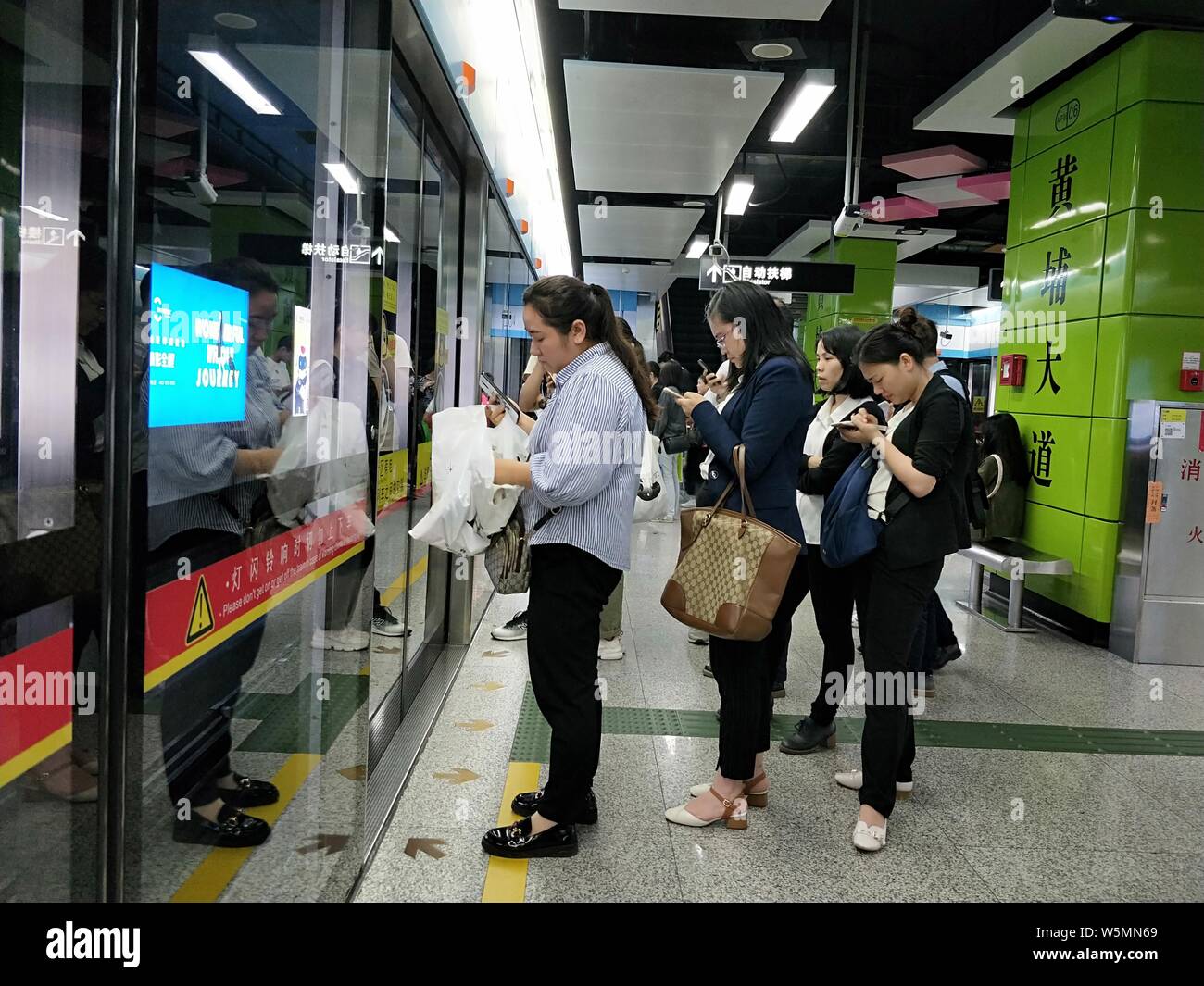 Passengers wait for their subway trains of Zhujiang New Town Automated ...