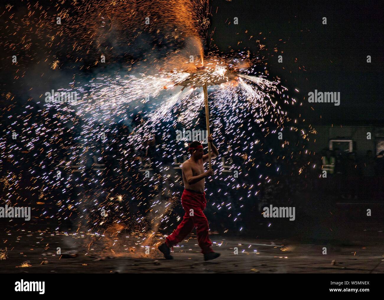 Chinese villagers push the paper tiger and flames were splashed high ...