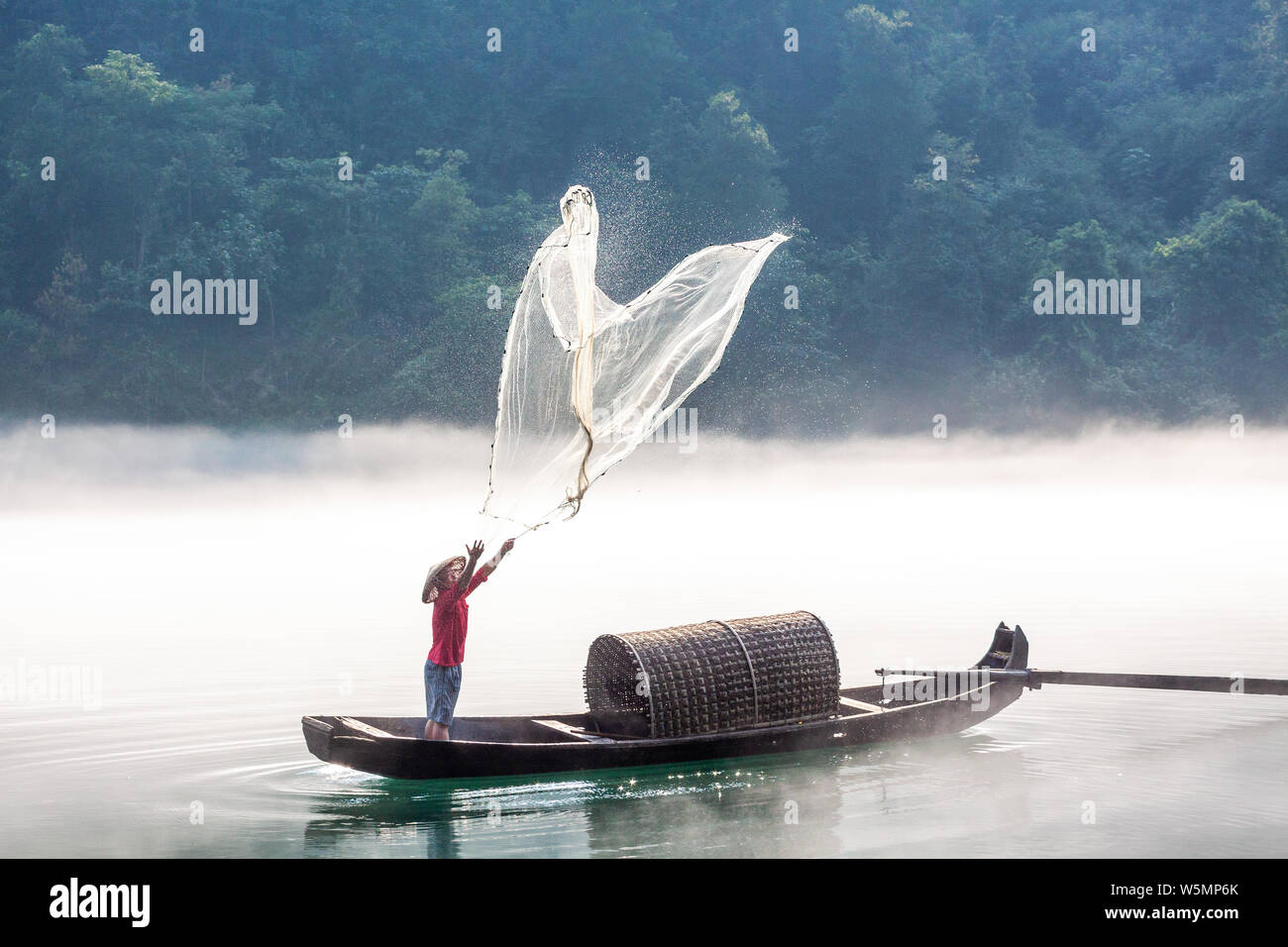 In this undated photo, a Chinese fisherman harvests fish along the ...
